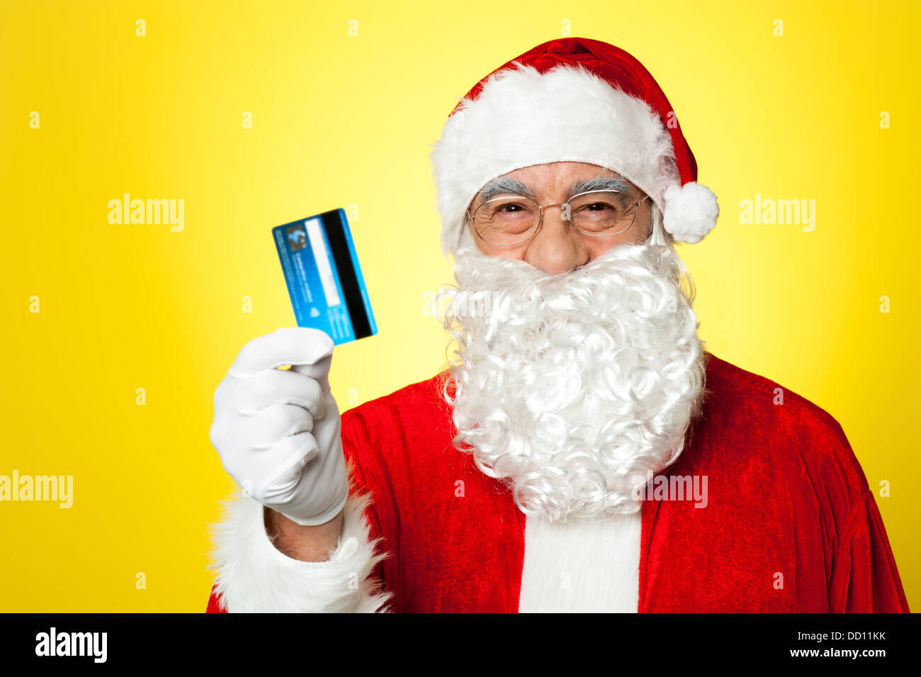 Aged man in Santa clothing ready to shop this Christmas, holding debit ...