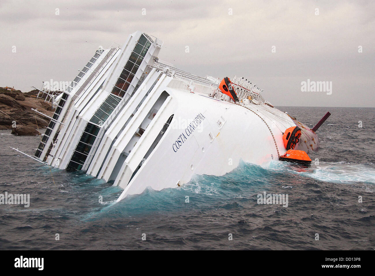 The cruise ship Costa Concordia lies stricken off the shore of the ...