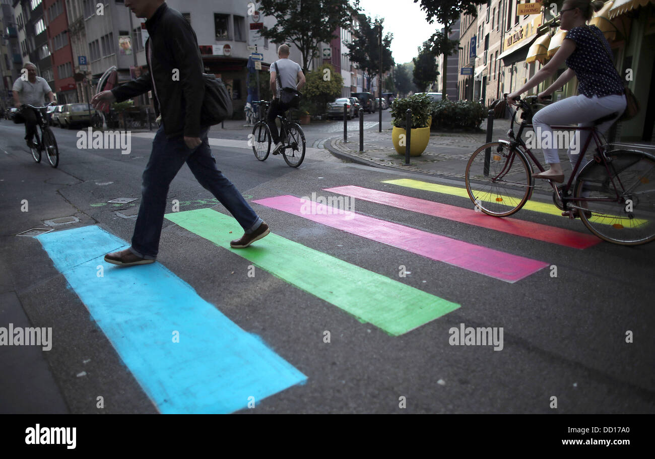 Cologne, Germany. 23rd Aug, 2013. A man goes over a crosswalk painted ...