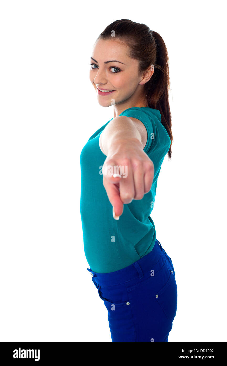 Pretty girl isolated over white pointing at you Stock Photo - Alamy