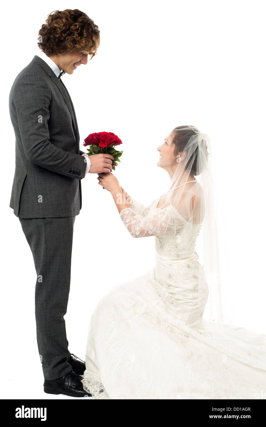 Gorgeous bride kneeling down and proposing handsome guy Stock Photo - Alamy