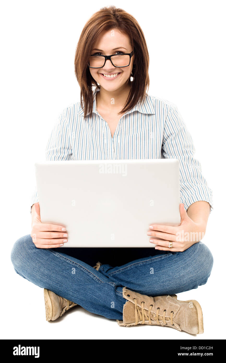 Bespectacled young woman sitting on the floor with laptop Stock Photo ...
