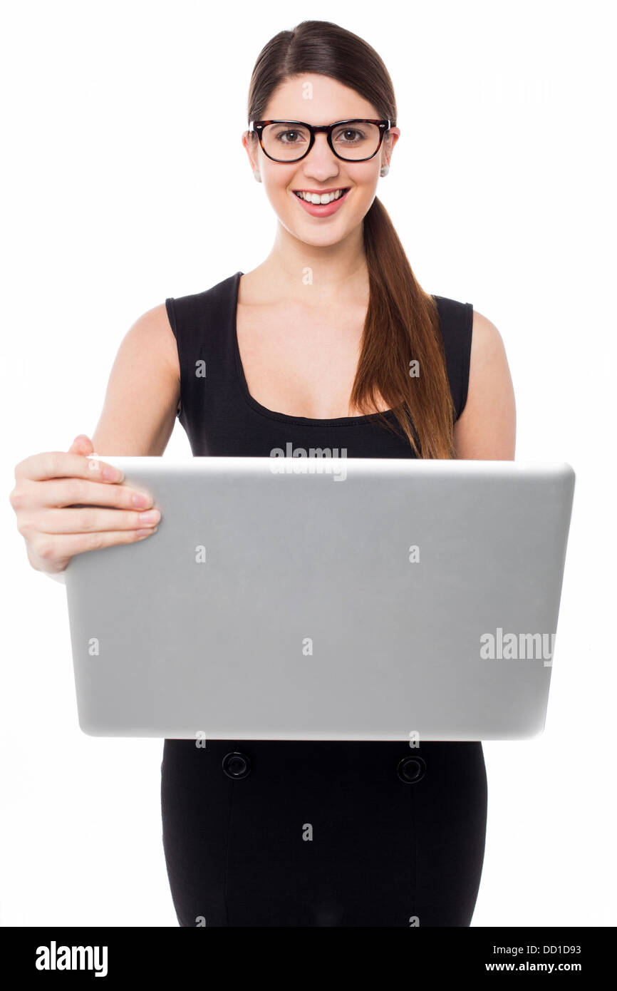 Stylish business executive posing with a laptop over white background ...