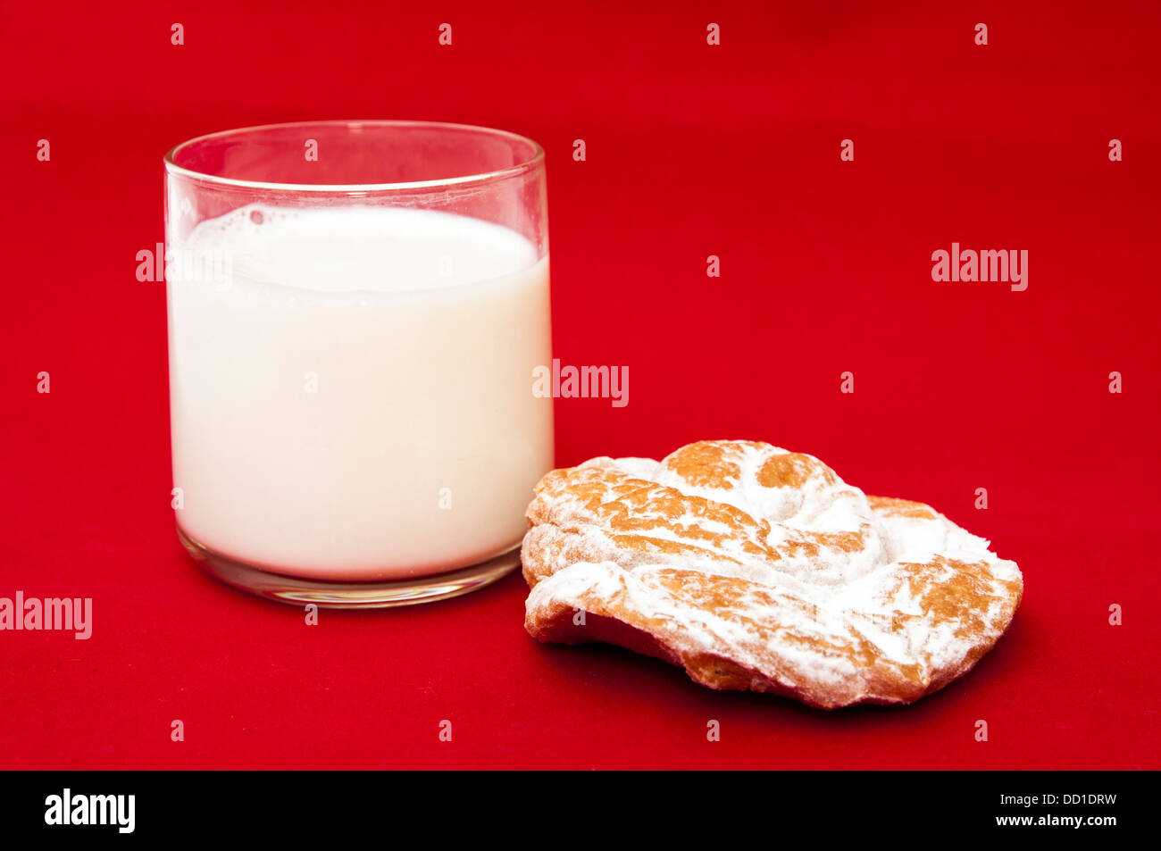 ensaïmada glass of milk on a red background Stock Photo - Alamy