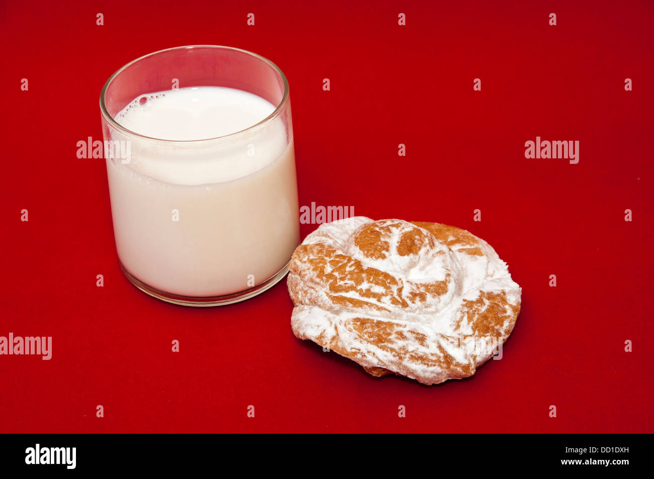ensaïmada glass of milk on a red background Stock Photo - Alamy