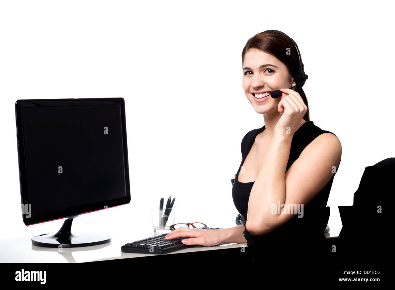 Pretty female support staff attending clients queries Stock Photo - Alamy