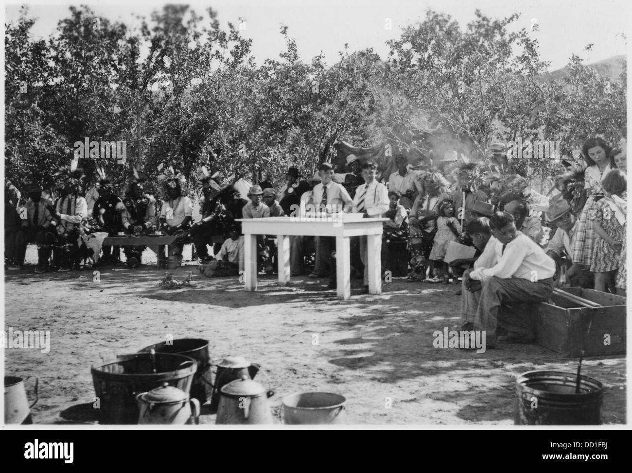 This photograph captures an outdoor tribal gathering, likely an ...