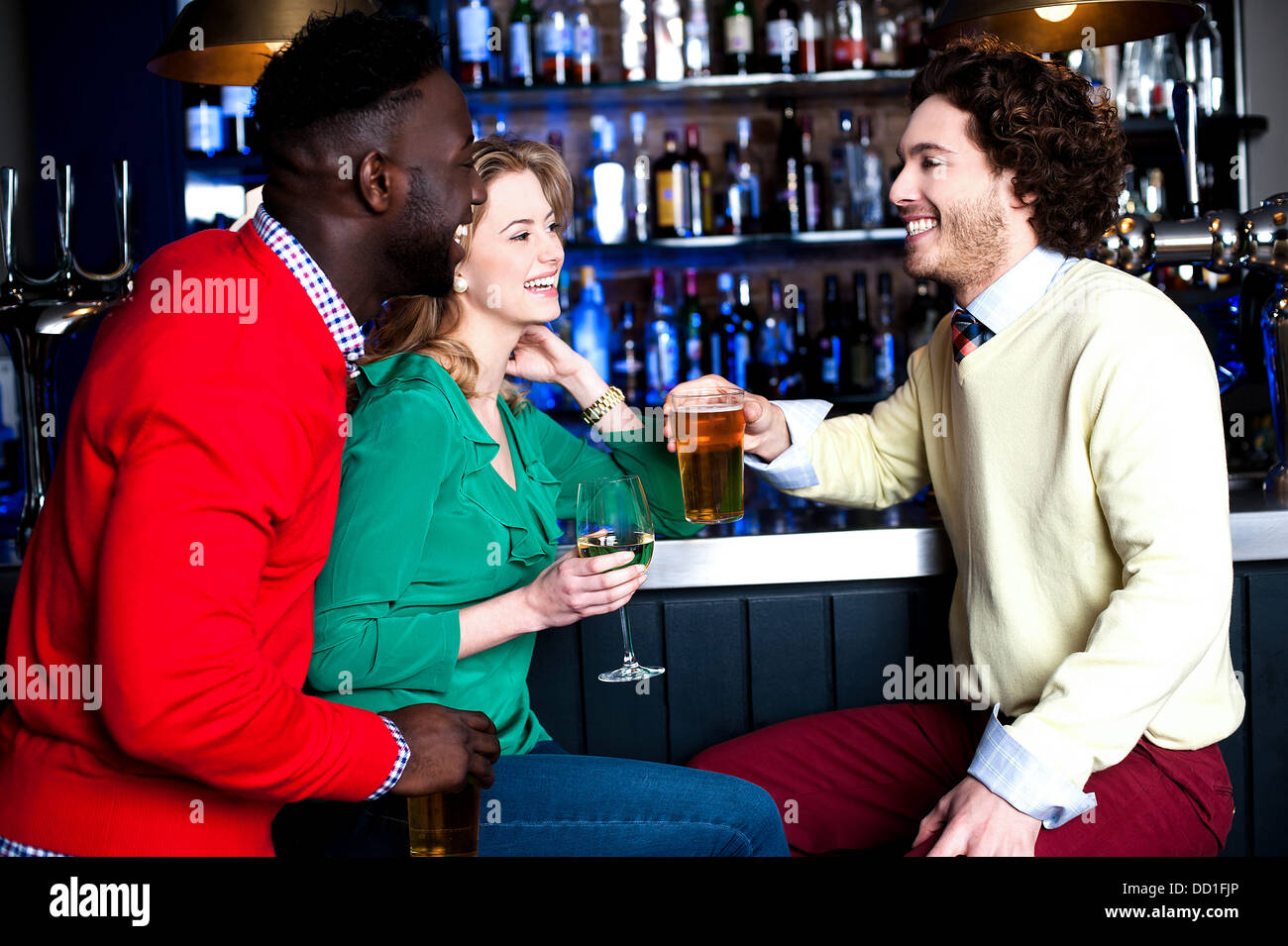 Friends having good time together in a bar Stock Photo - Alamy