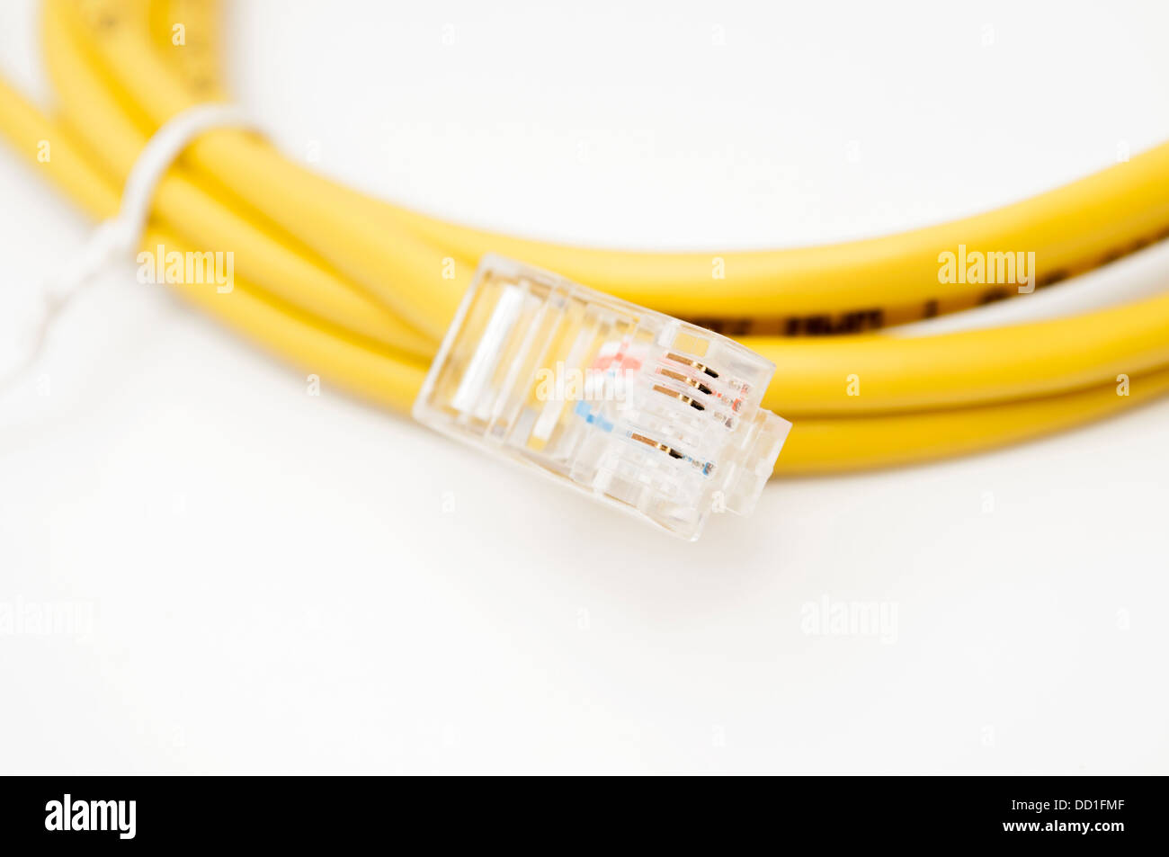 telephone cable yellow on a white background Stock Photo - Alamy