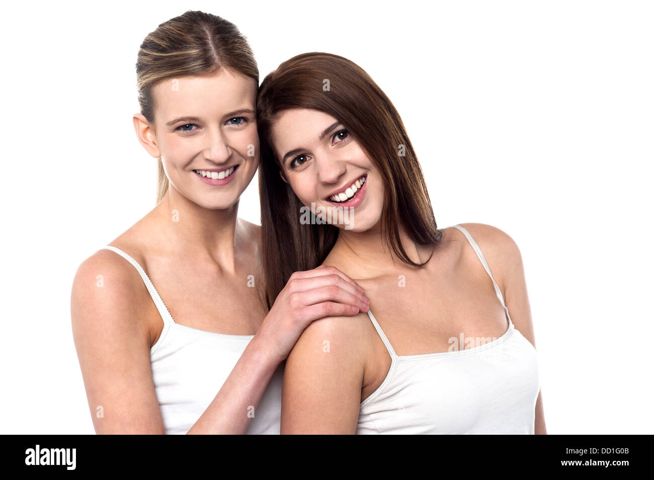 Smiling attractive friends wearing sleeveless spaghetti and posing ...
