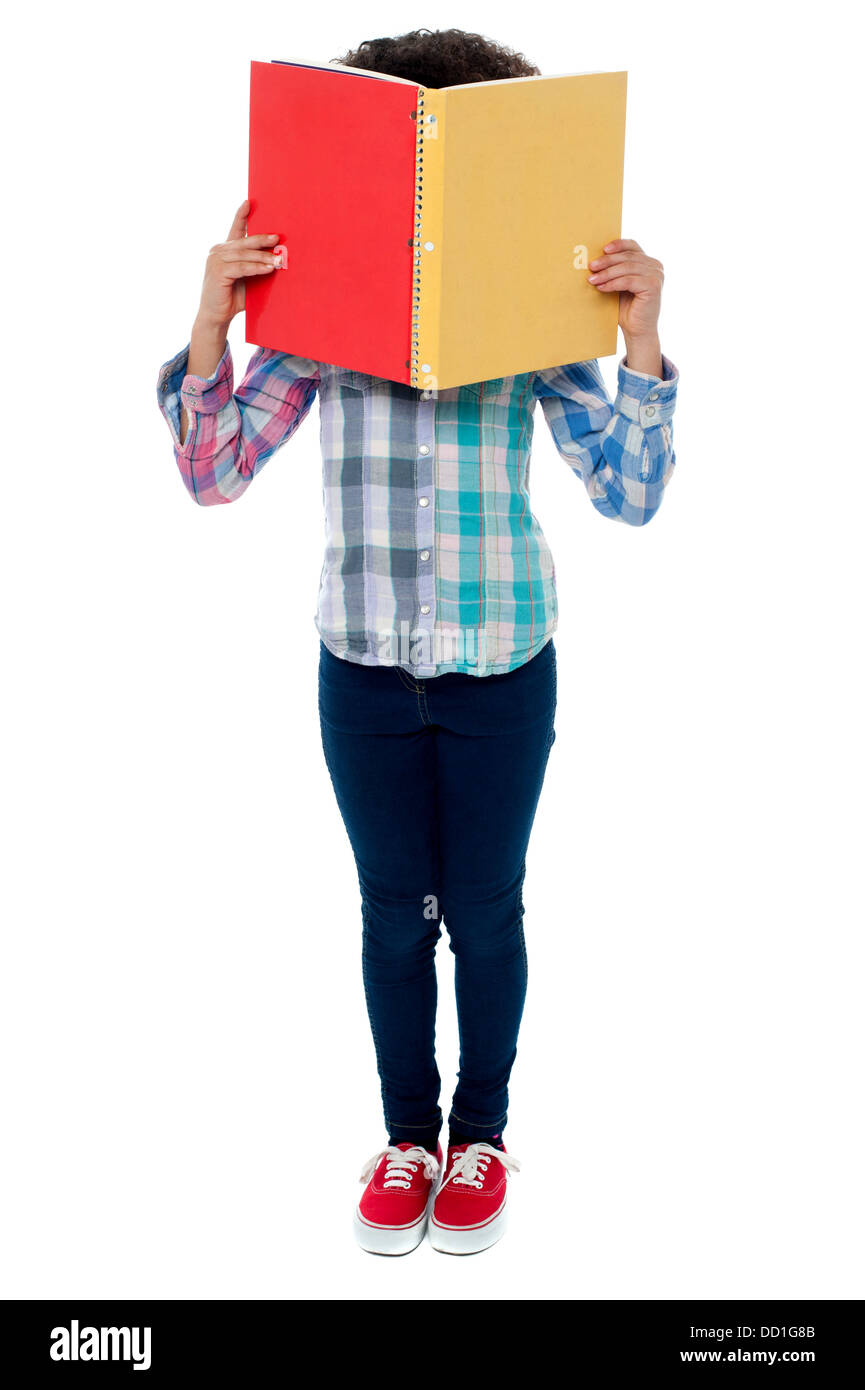 Shy school girl hiding her face behind colored notebook Stock Photo - Alamy