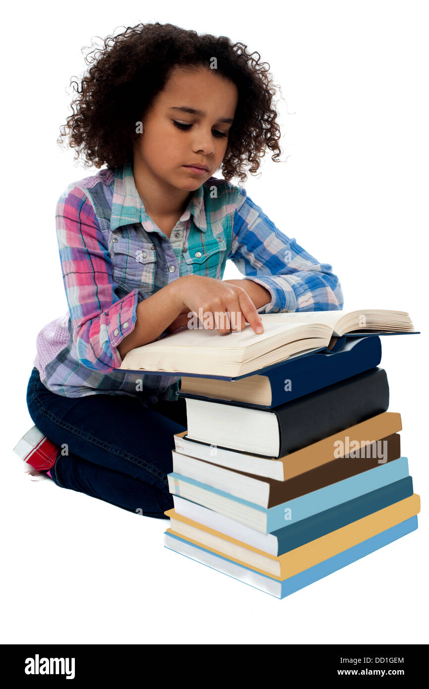 Focused school girl reading a book and learning Stock Photo - Alamy
