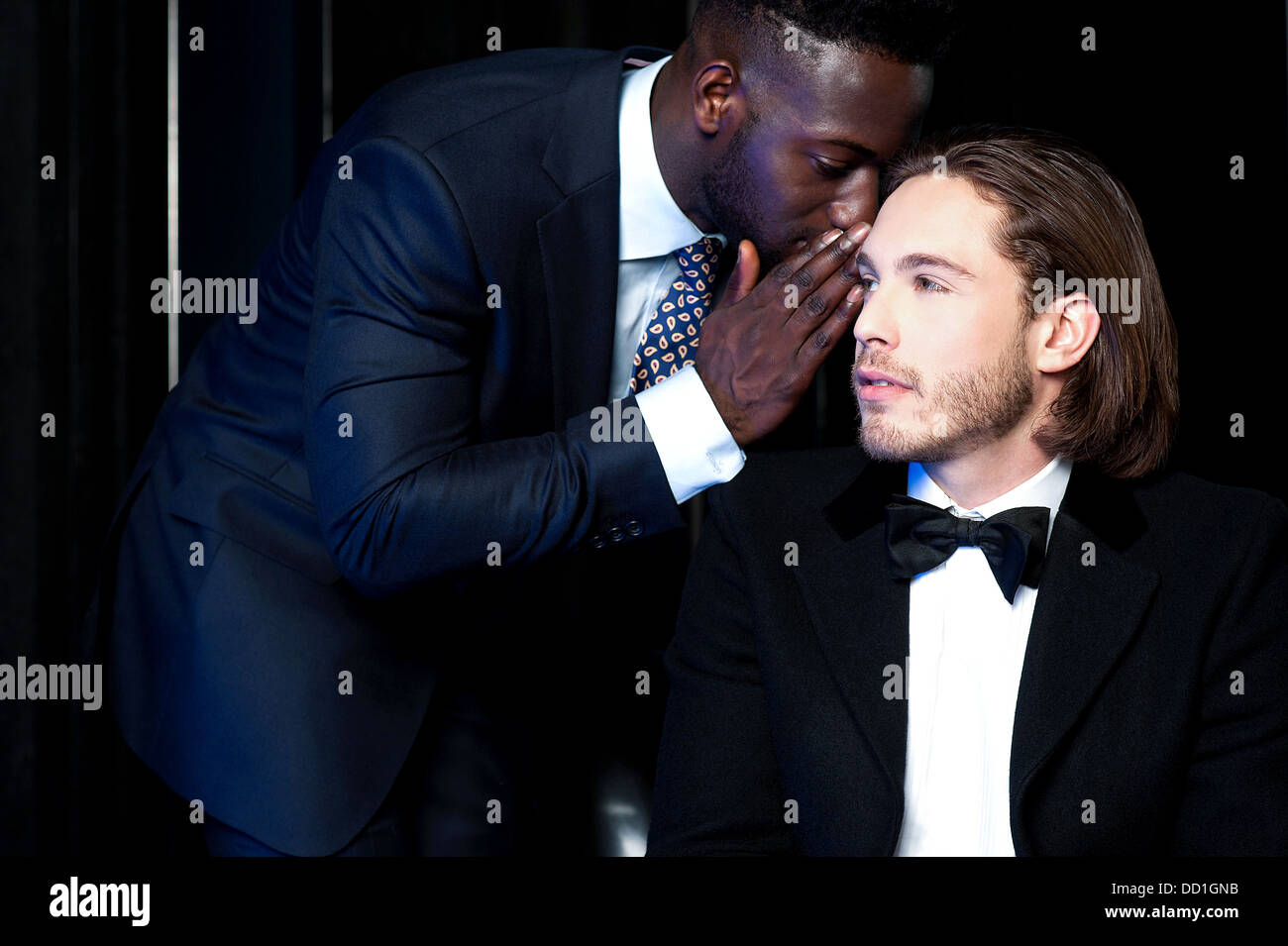 Secretary whispering something into the ears of his boss Stock Photo ...