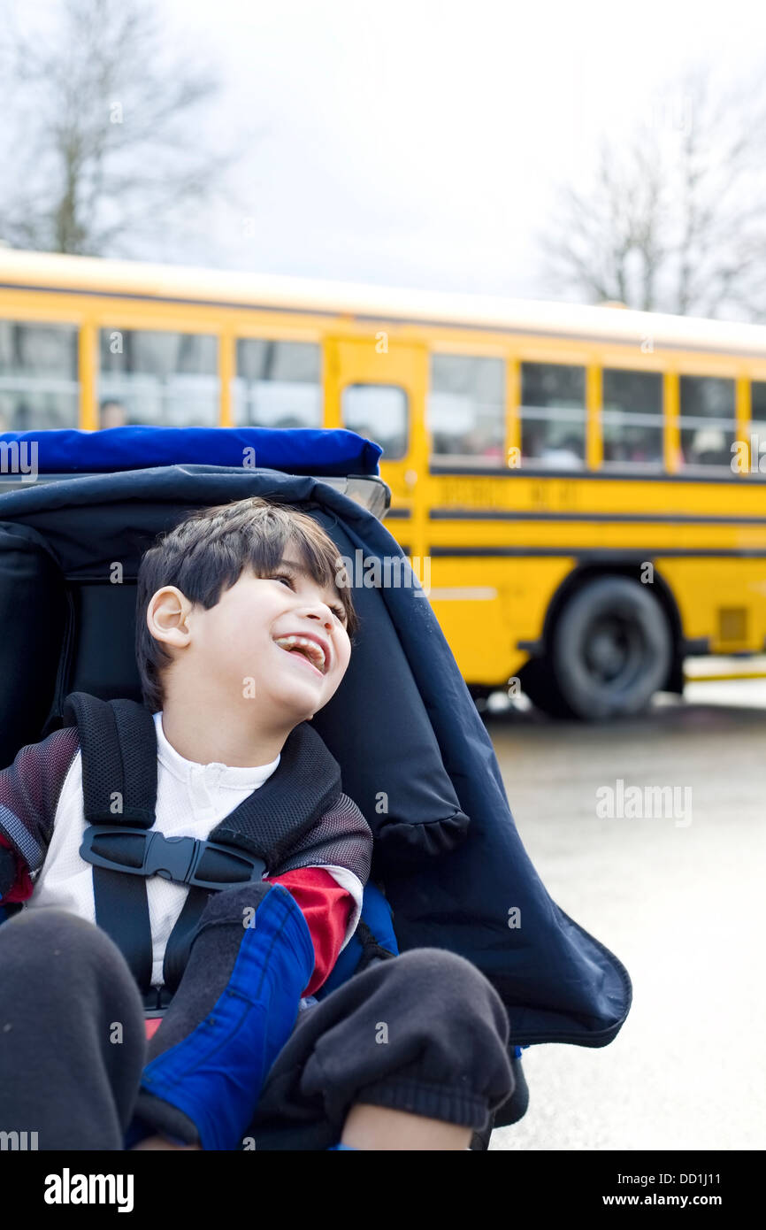 Disabled five year old boy in wheelchair, by schoolbus Stock Photo - Alamy