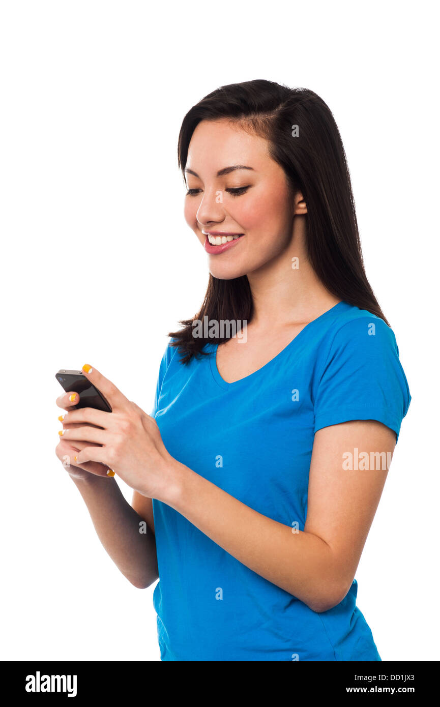 Young girl sending text message to her boy friend through cellphone ...