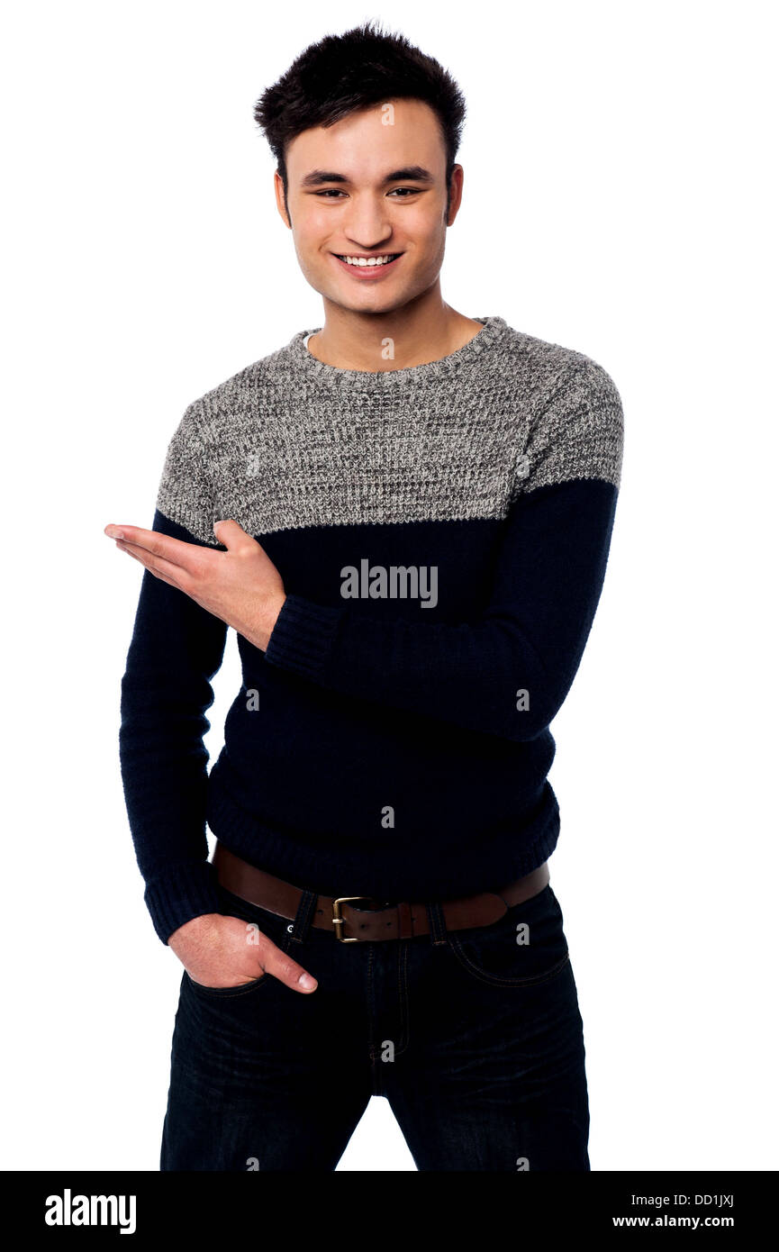 Smart young guy pointing away with one hand in his pocket Stock Photo ...