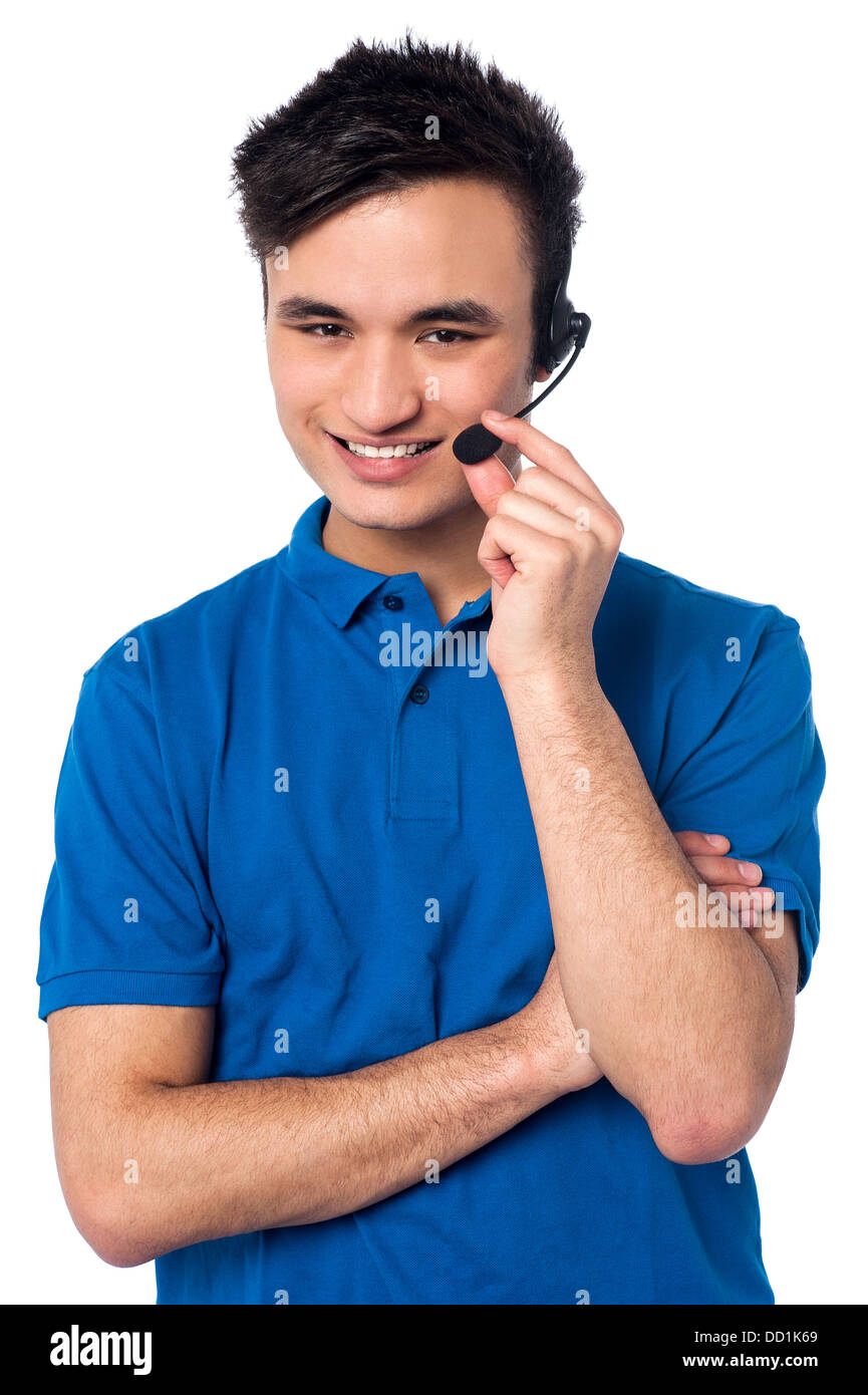 Smiling call center agent adjusting his microphone Stock Photo - Alamy