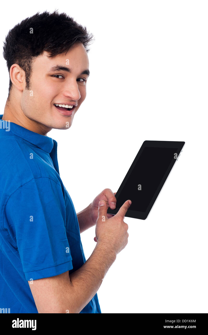 Young handsome guy operating touch pad Stock Photo - Alamy