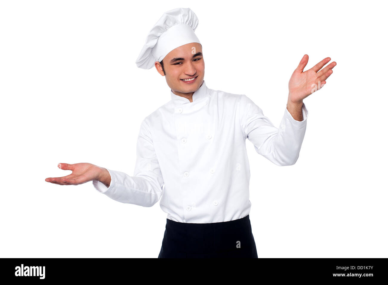 Young smart male chef welcoming his guests Stock Photo - Alamy
