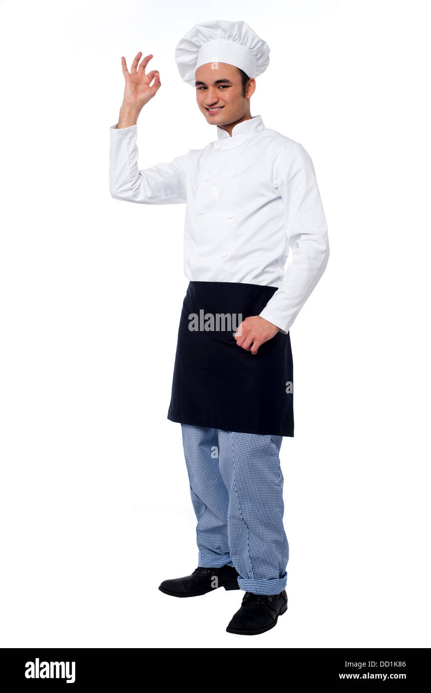 Smiling male chef showing fantastic gesture after tasting delicious ...