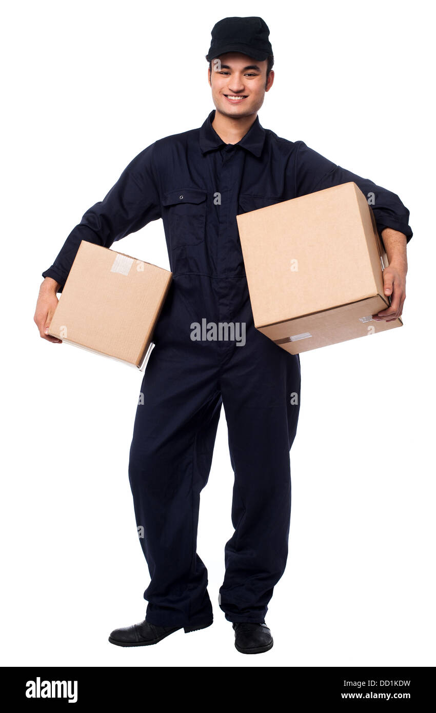 Smiling courier guy in blue uniform holding parcels in both hands Stock ...