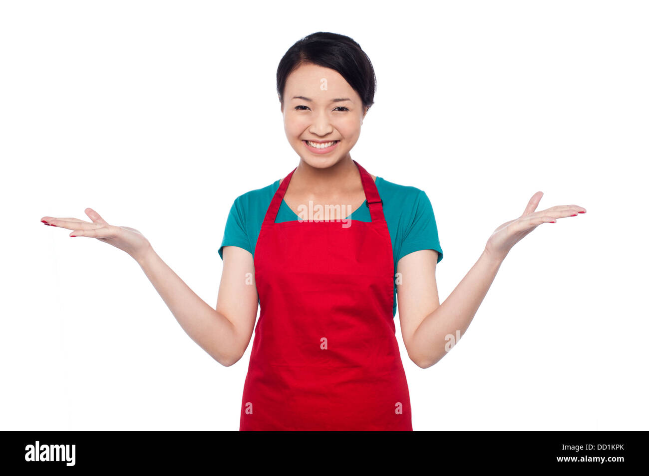Young female chef standing with warm welcome gesture Stock Photo - Alamy