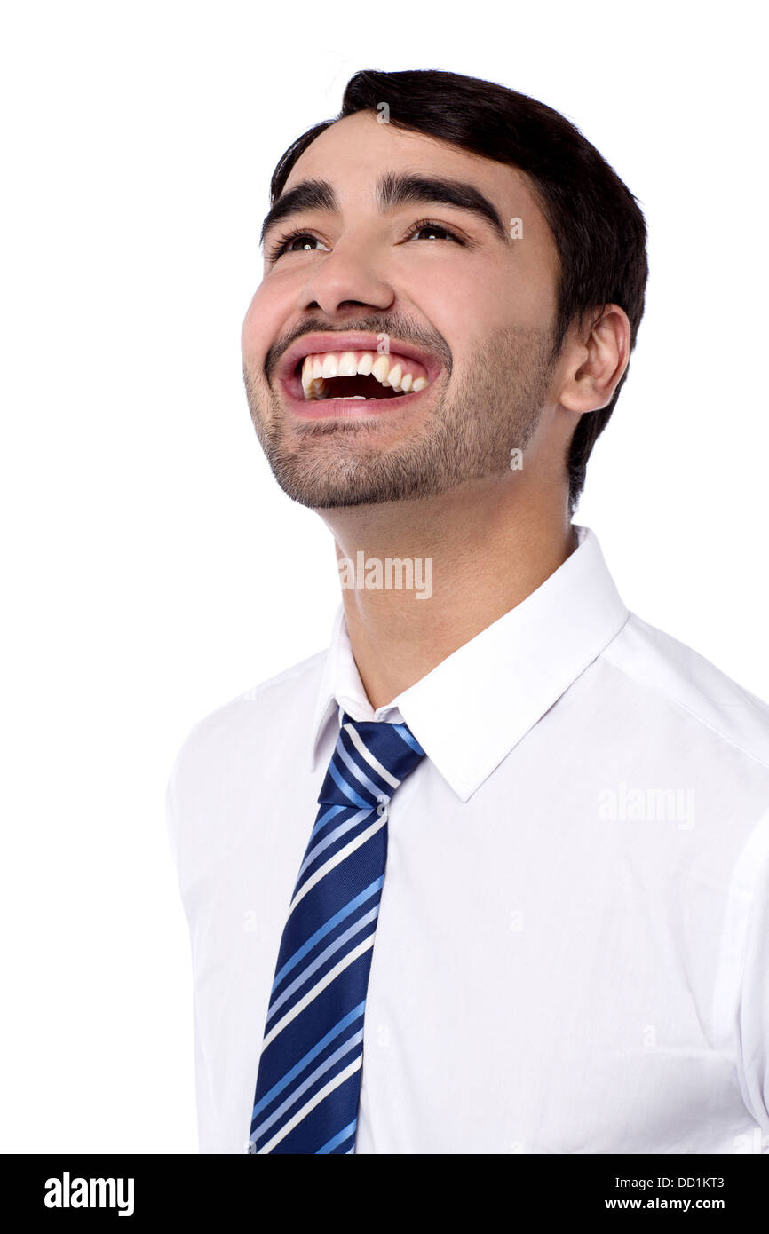 Cheerful young businessman looking upwards, studio shot Stock Photo - Alamy