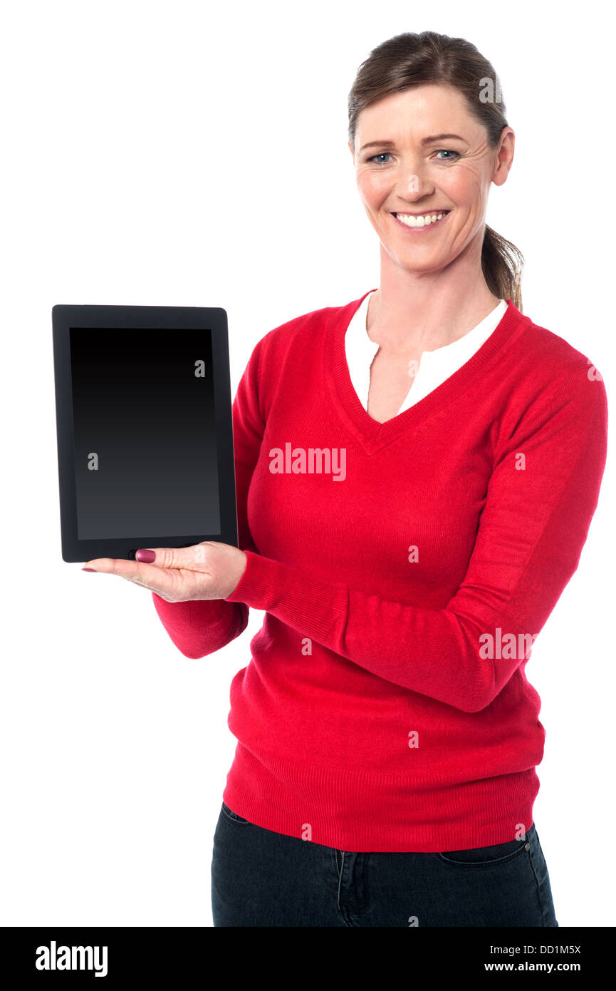 Pretty saleswoman displaying newly launched tablet device for sale ...