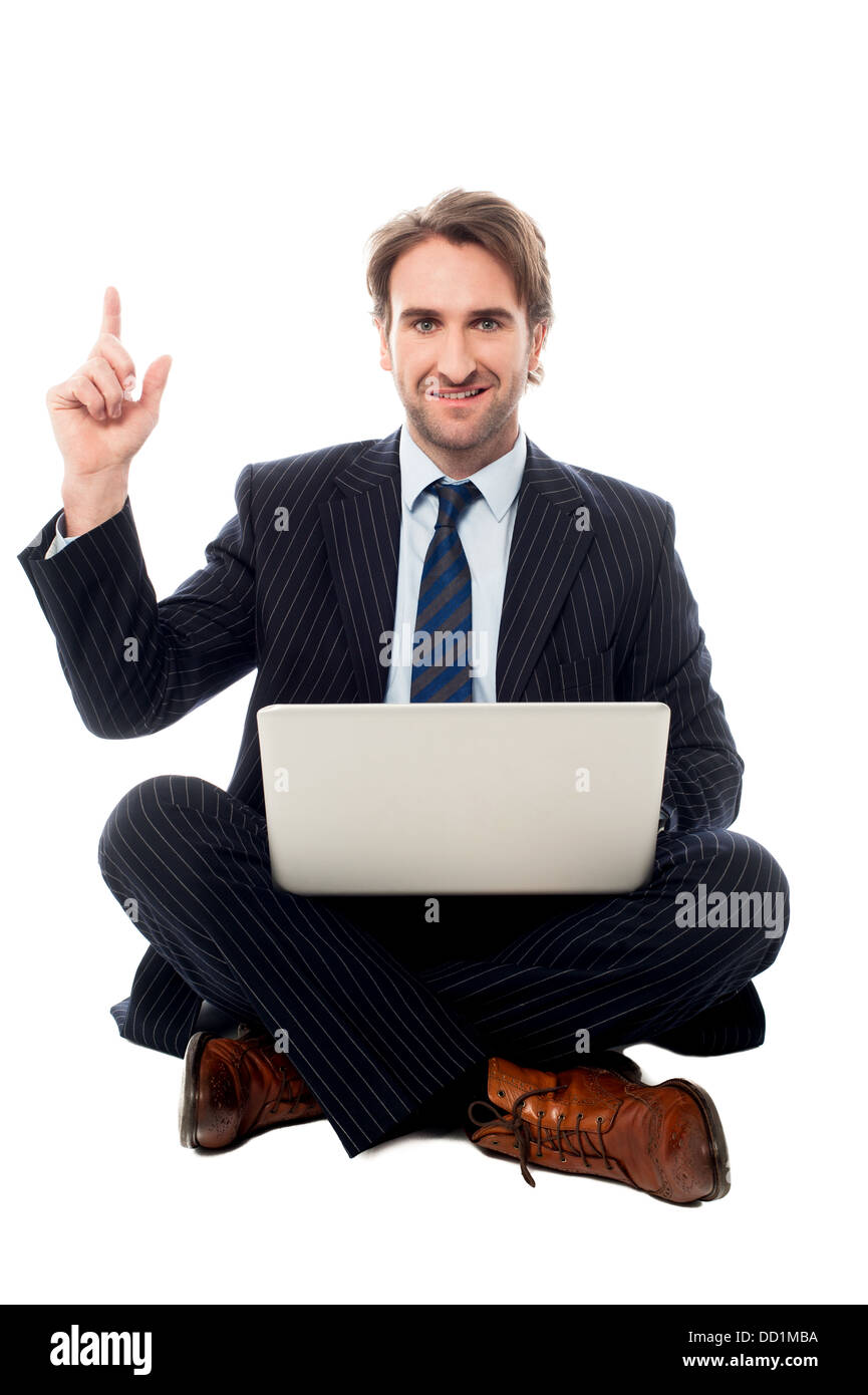Male manager sitting on floor with laptop Stock Photo - Alamy