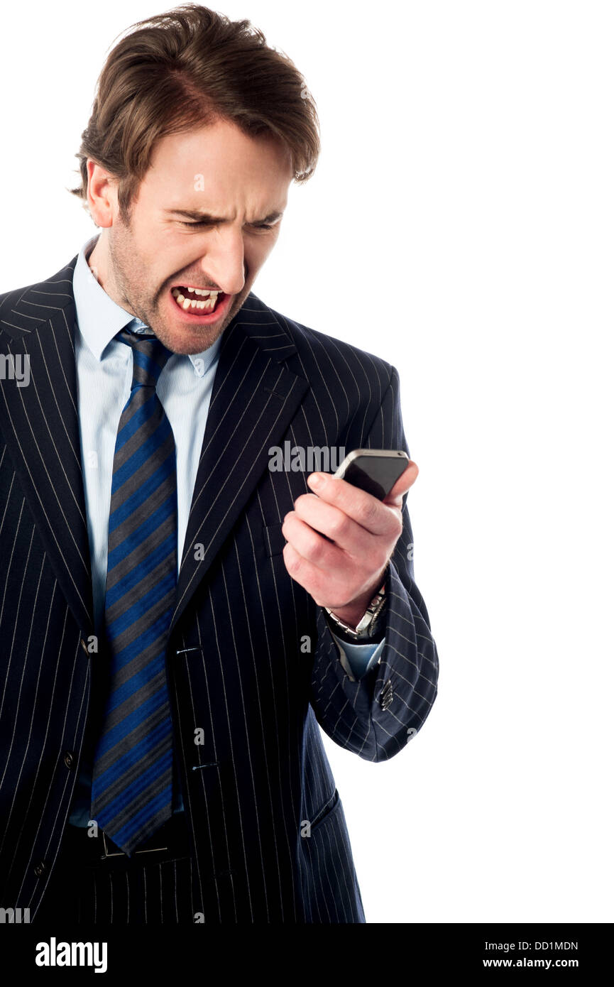 Annoyed business professional looking at his phone Stock Photo - Alamy