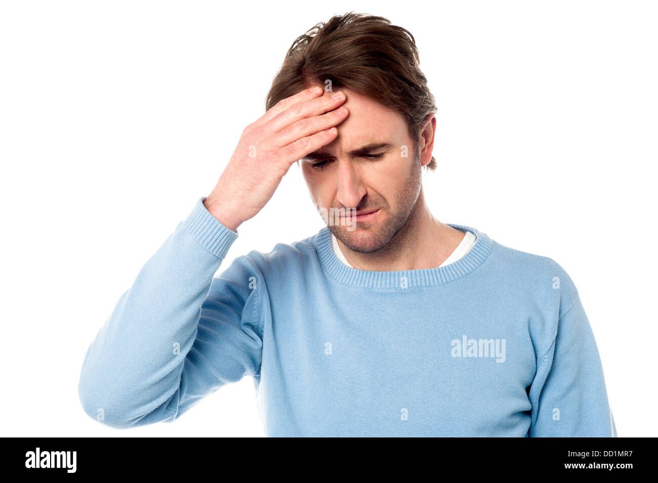 Man suffering from headache wincing Stock Photo - Alamy