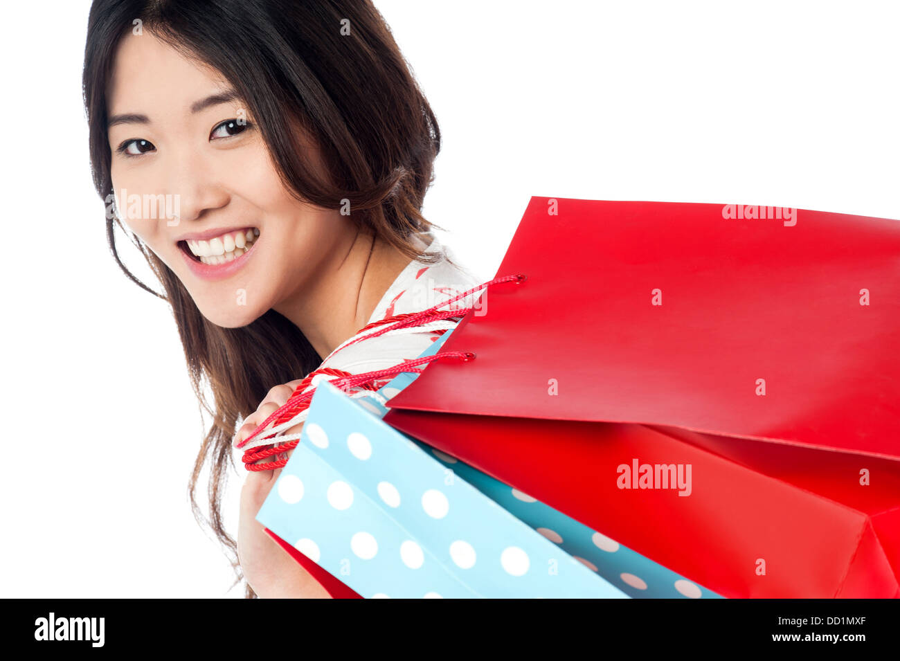 Girl with shopping bags slung over her shoulder Stock Photo - Alamy