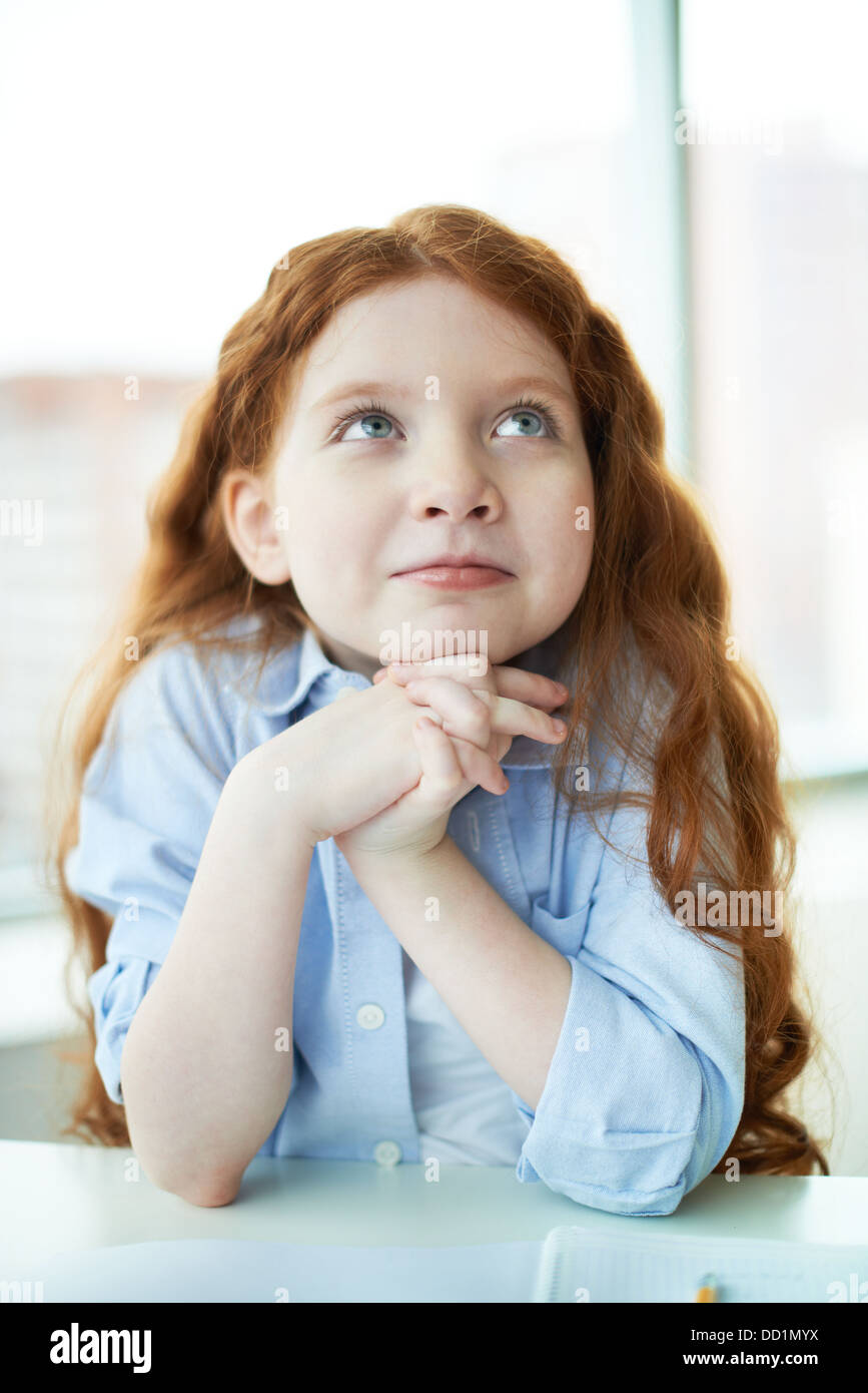Pensive little girl thinking about something Stock Photo - Alamy
