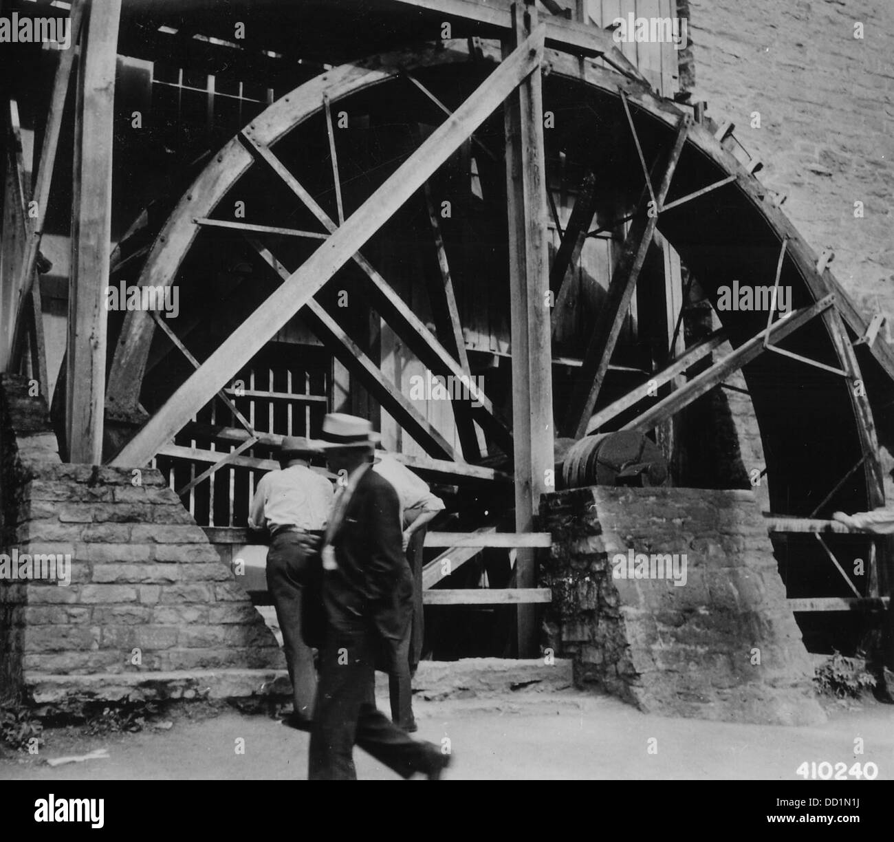 This image shows a waterwheel powering a grist mill, demonstrating an ...