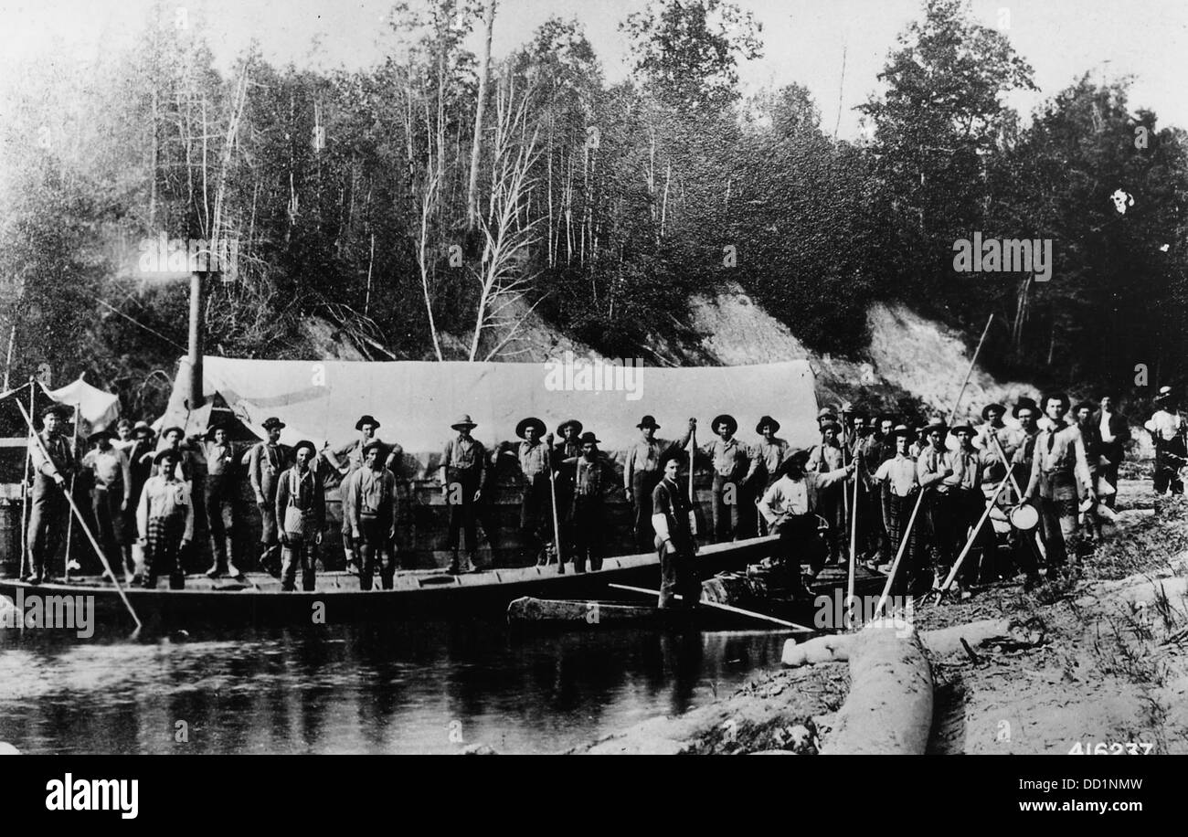 This photograph depicts a crew of men operating a batteau on the ...