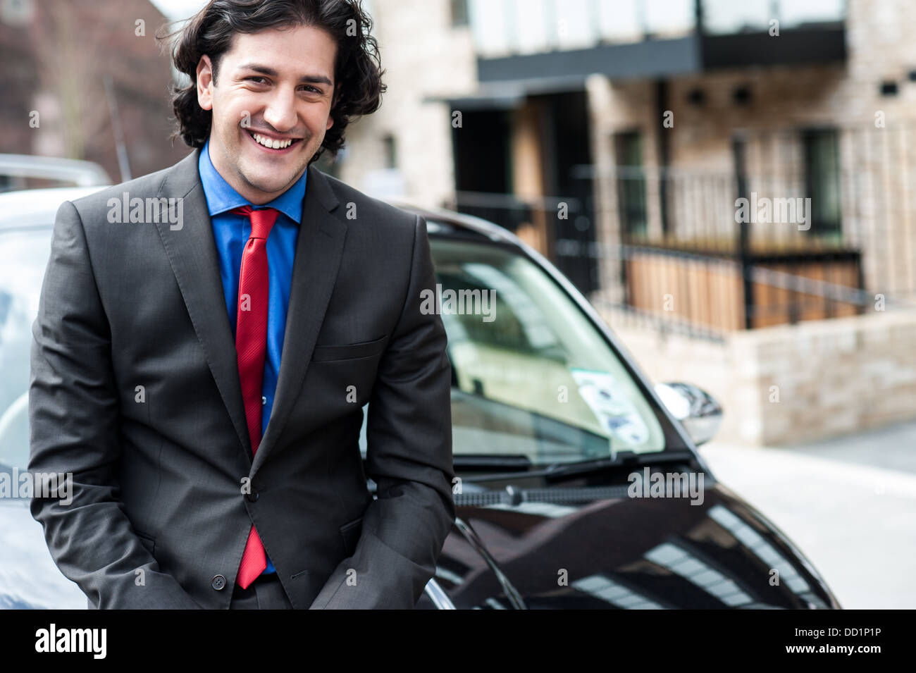 Smiling young handsome executive posing in style Stock Photo - Alamy