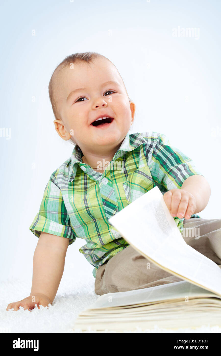 Portrait of happy boy with open book laughing Stock Photo - Alamy