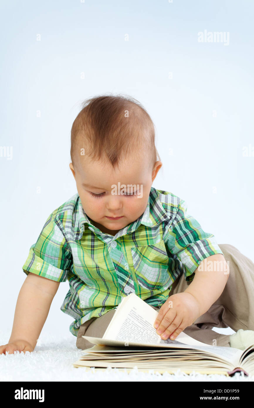 Portrait of calm boy turning pages of book over white background Stock ...