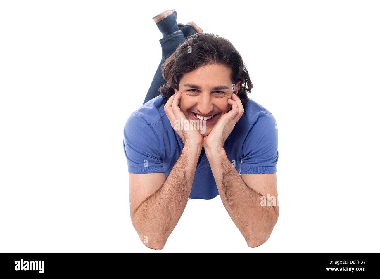 Young smiling man lying on the floor, studio shot Stock Photo - Alamy