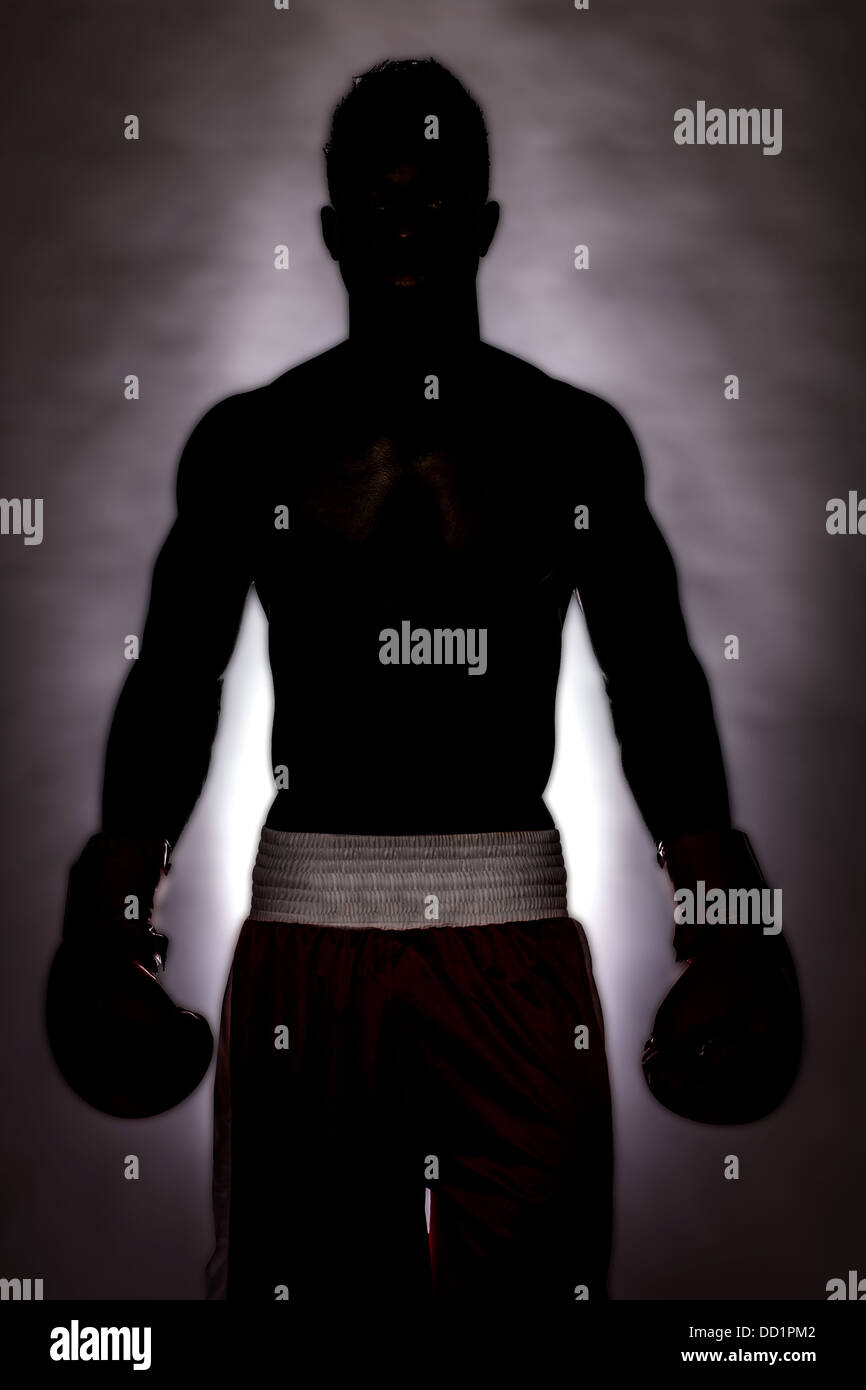 Macho male boxer with gloves on posing in dark Stock Photo - Alamy