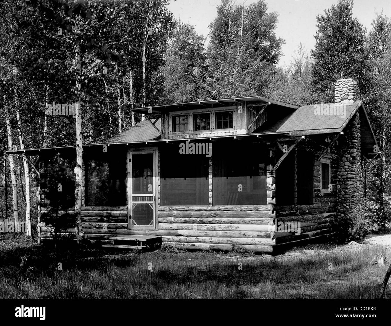 This photograph shows a rustic cabin constructed from slabs, located ...