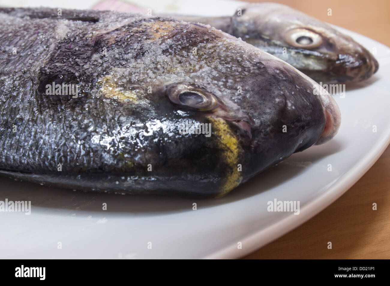 2 fish in a plate close-up Stock Photo - Alamy