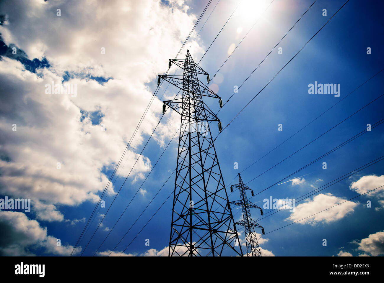 Power towers with blue sky and clouds Stock Photo - Alamy