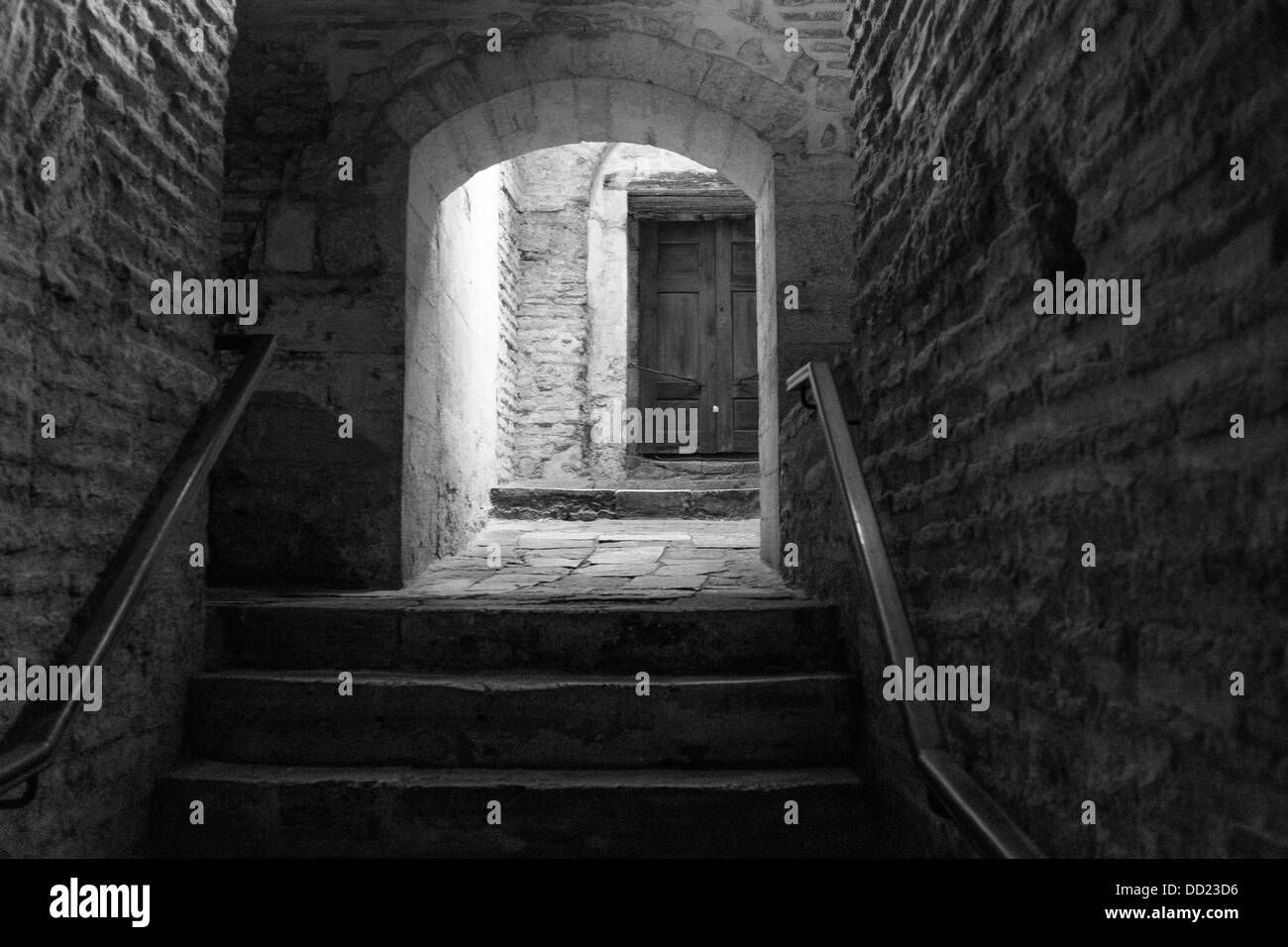 Black and white alley way leading to old door Stock Photo - Alamy