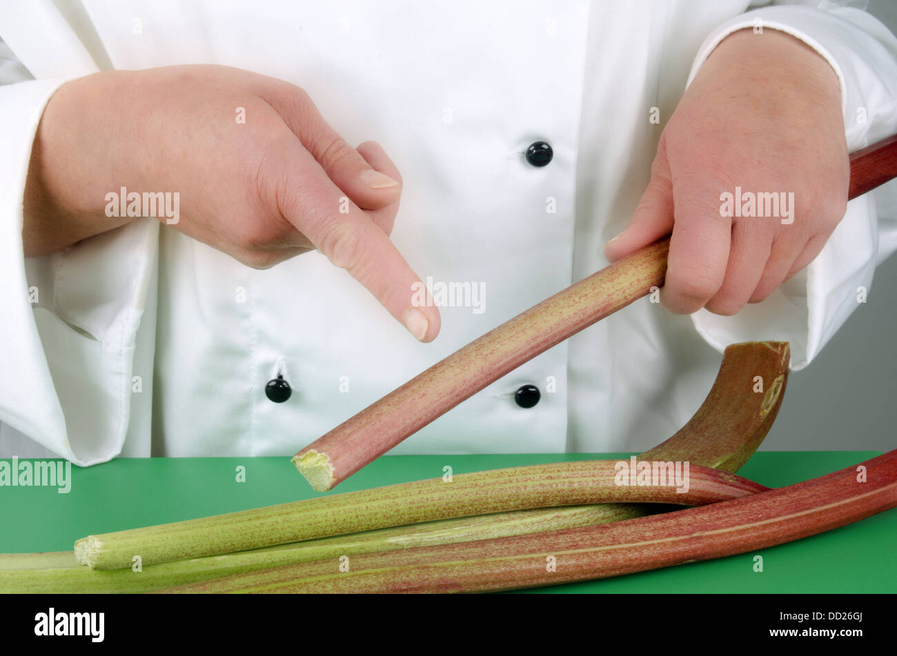 female chef shows with her index finger on rhubarb Stock Photo - Alamy