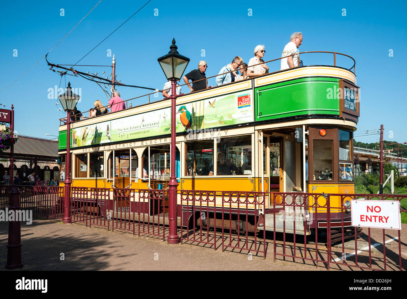 Electric tramway at Seaton, Devon, UK. People on holiday enjoy a ride ...