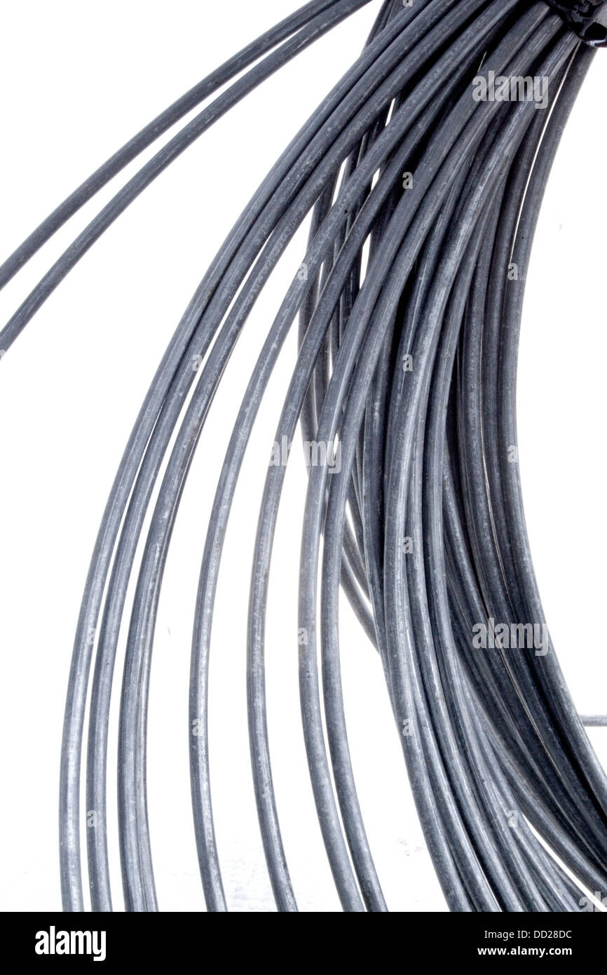 An abstract studio shot of a coil of unravelling thick metal wire on an ...