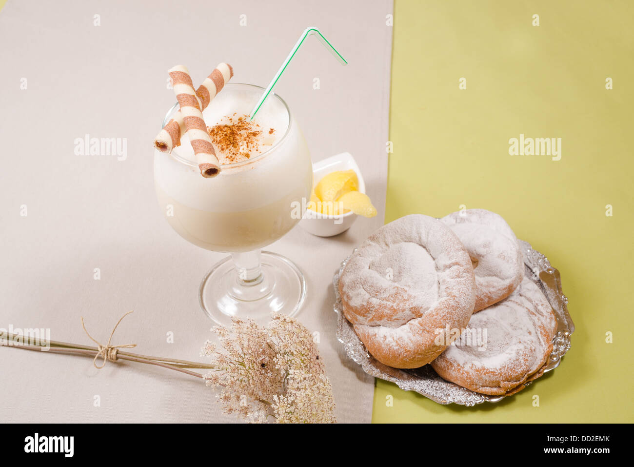 An aromatic milkshake, leche preparada, with sweet ensaimadas, a ...