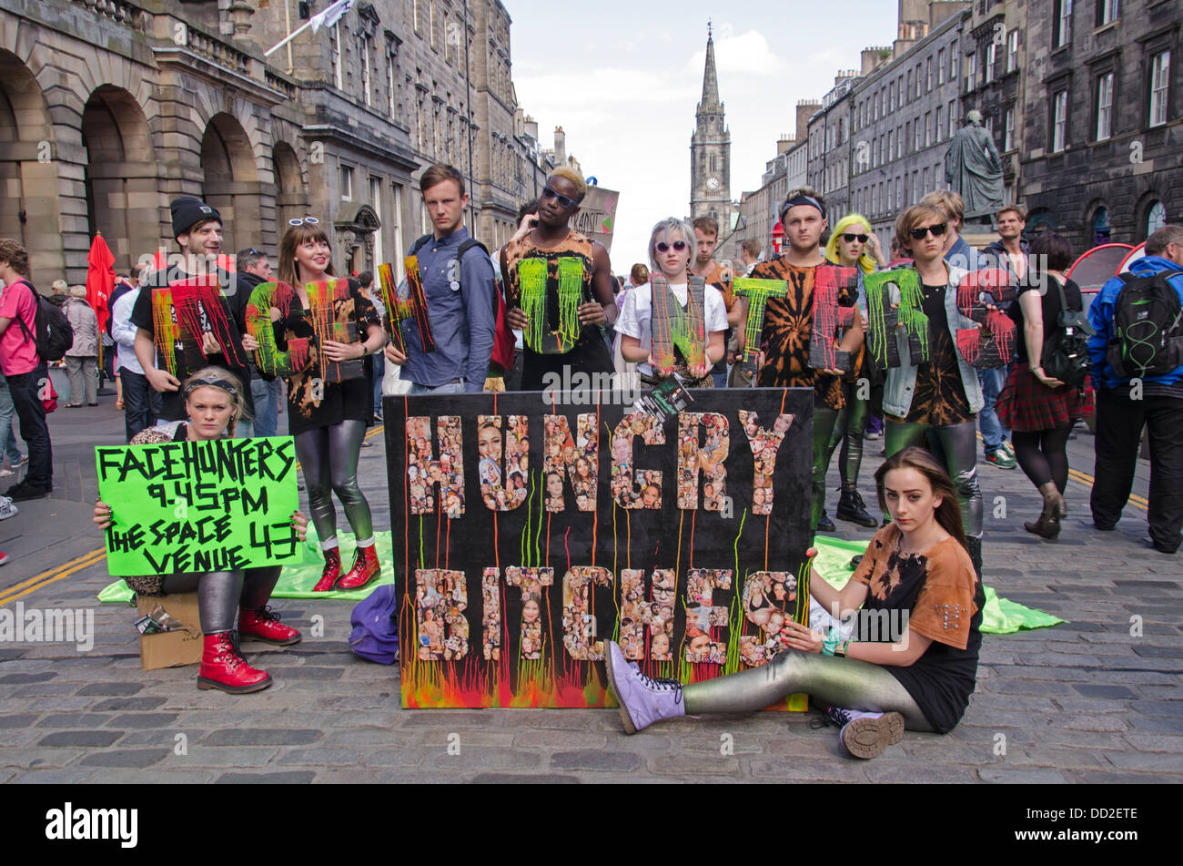 Performers promoting their play "Facehunters" on the High Street in ...