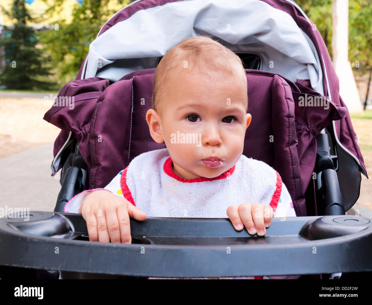 Eat smeared pretty baby girl eating outdoor Stock Photo - Alamy